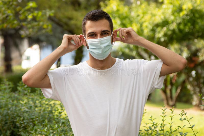 Man Putting on Mask Outdoors Stock Photo - Image of health, lifestyle ...