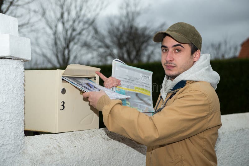 Man Putting Newspaper from the Mailbox Stock Image - Image of letterbox ...