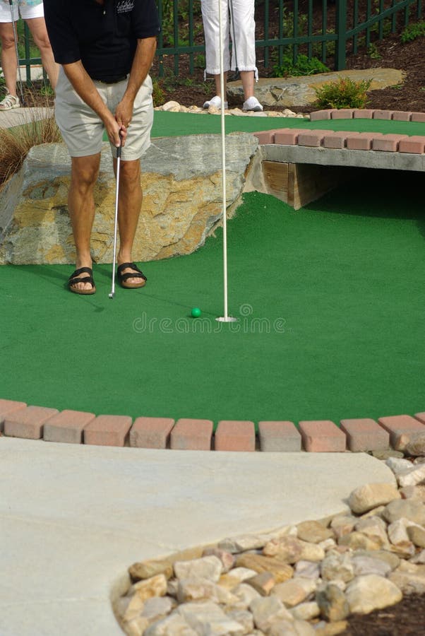 Man Putting on a Putt Puut Course. Stock Image - Image of front, long ...