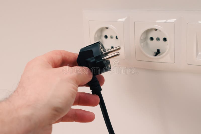 Man Putting on or Removing Electric Plug Cable in Socket, Closeup ...