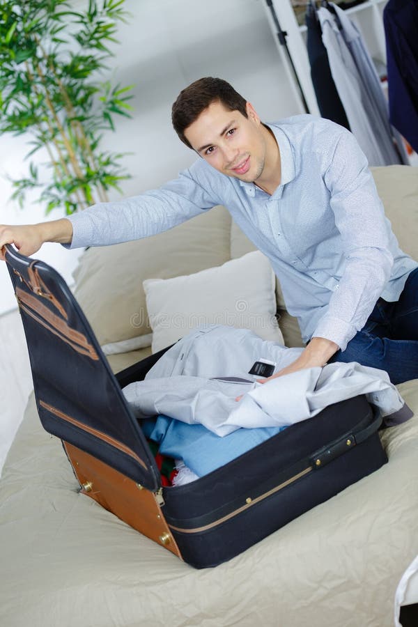 Man Putting Shirt into Suitcase Stock Image - Image of horizontal ...