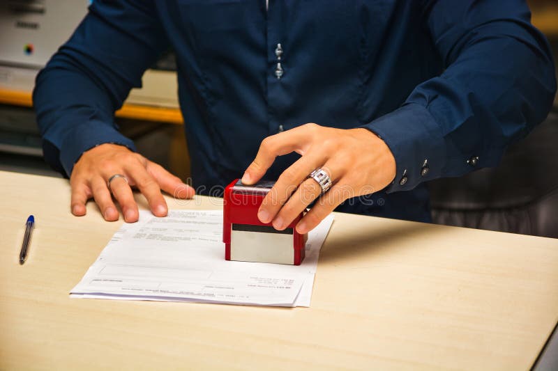 Photo of a Man Stamping a Document Stock Photo - Image of contract ...