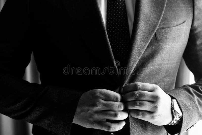 The Man is Wearing a Black Suit Stock Image - Image of style, puts ...