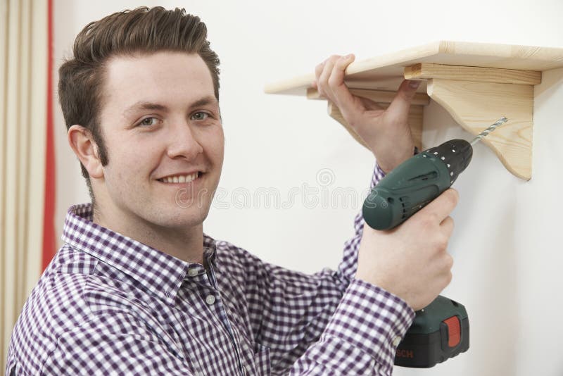 Man Putting Up Wooden Shelf at Home Using Electric Drill Stock Image ...