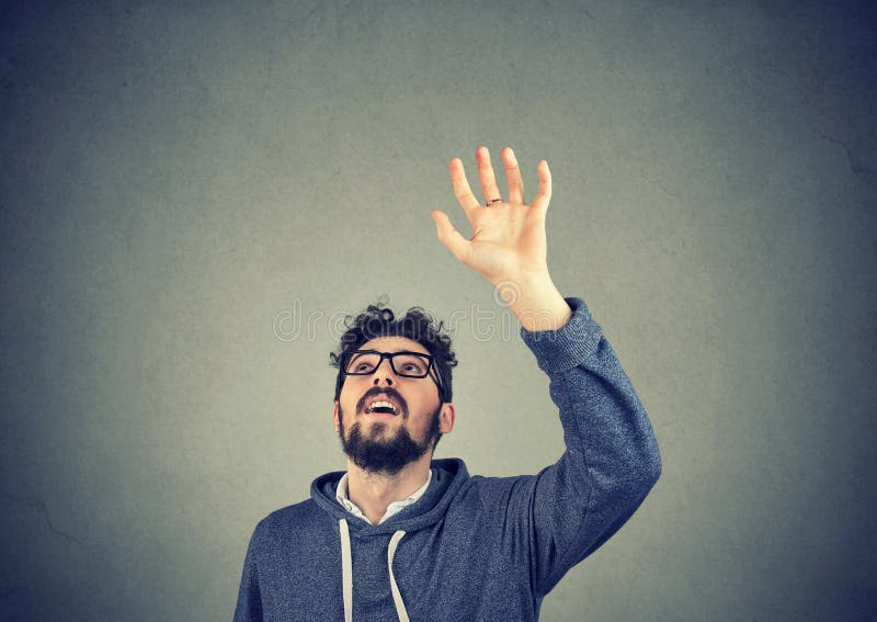 Man with a Raised Up Hand Trying To Catch Something Above Stock Photo ...
