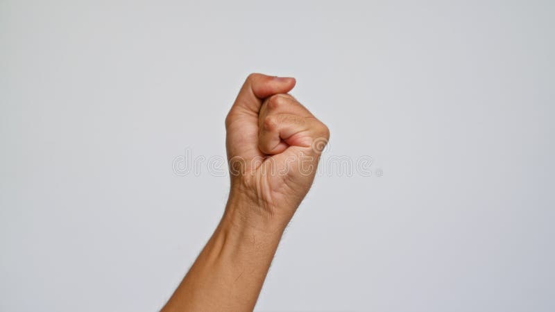 Man Raising Clenched Hand in Front of Plain White Background ...