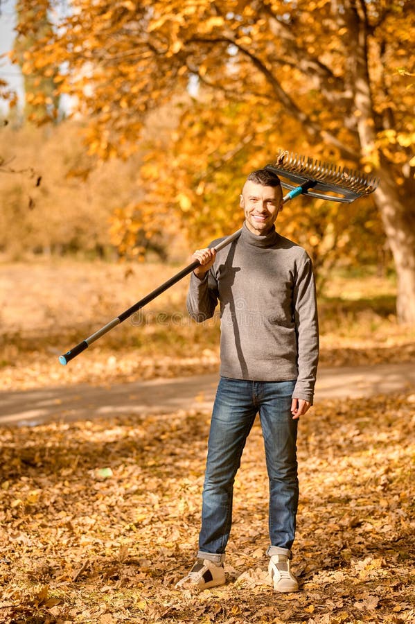 A Man with a Rake Standing in the Park Stock Image - Image of work ...
