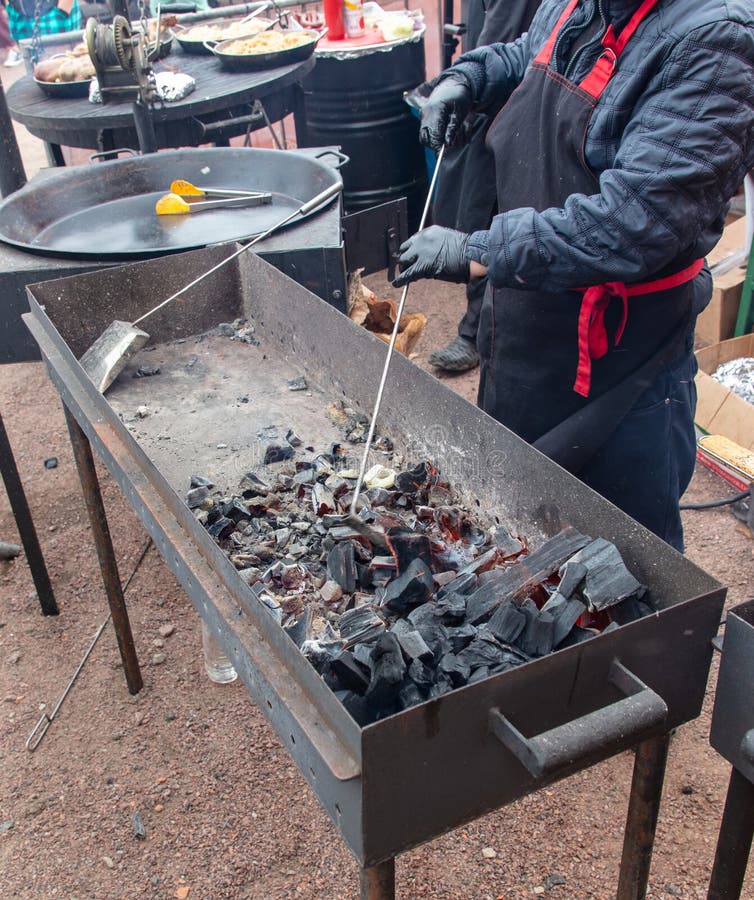 A Man Rakes Coals in a Barbecue Stock Image - Image of barbecue, heat ...