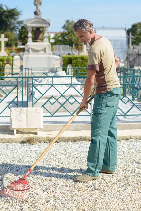 Man Raking Gravel in Cemetery Stock Photo - Image of burial, garden ...