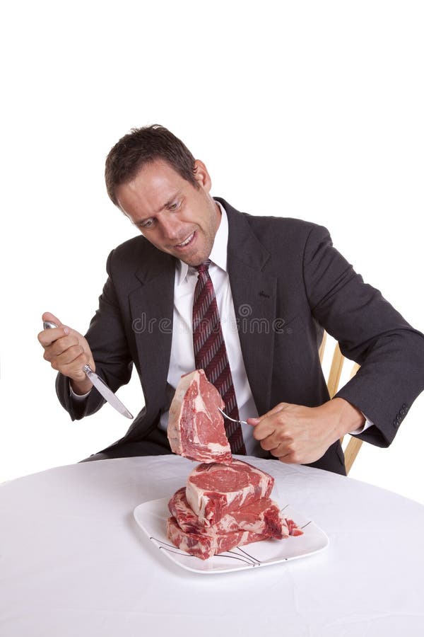 Man with raw steak eating stock photo. Image of dinner - 16011834