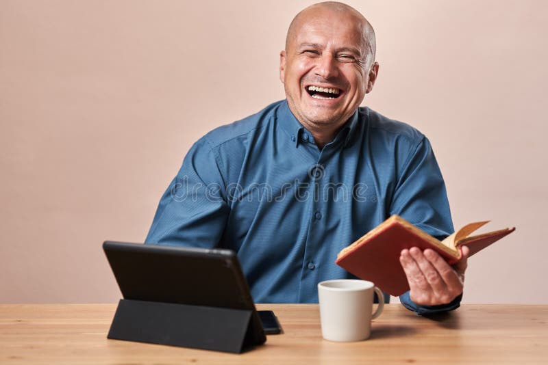 Man Reading an Amusing Book Stock Photo - Image of elegant, adult ...
