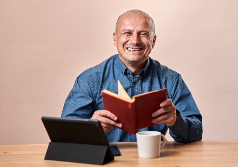 Man Reading an Amusing Book Stock Image - Image of white, humorous ...