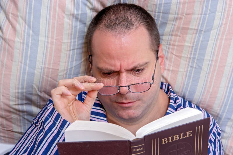 Man reading the Bible stock image. Image of pajamas, adult - 46746279