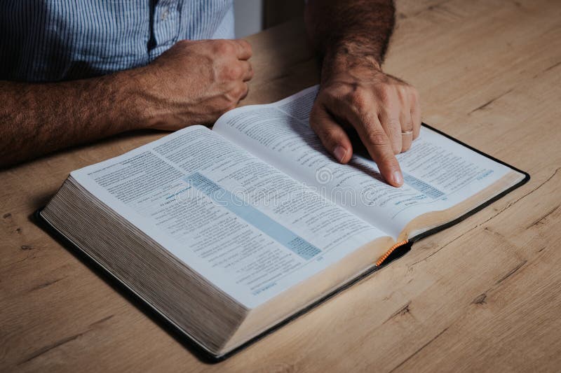 Man is Reading the Bible Pointing with His Finger at the Text Stock ...