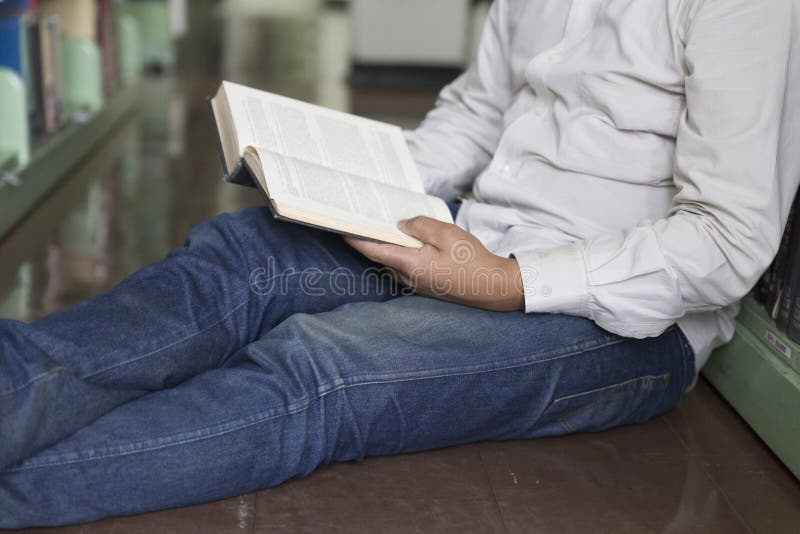 Man Reading Book in Aisle in Library Stock Photo - Image of study, male ...