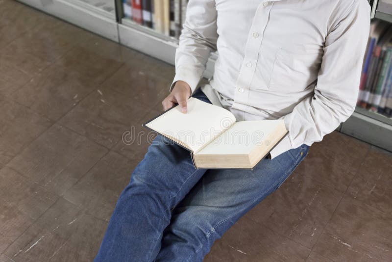 Man Reading Book in Aisle in Library Stock Photo - Image of reading ...