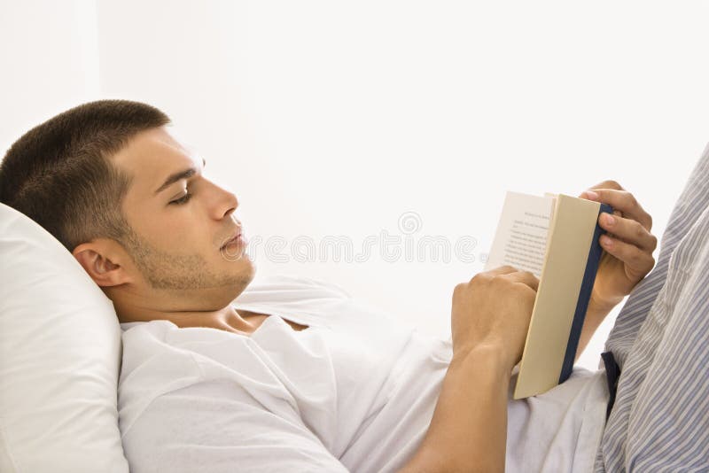 Man reading book in bed. stock photo. Image of caucasian - 3423736