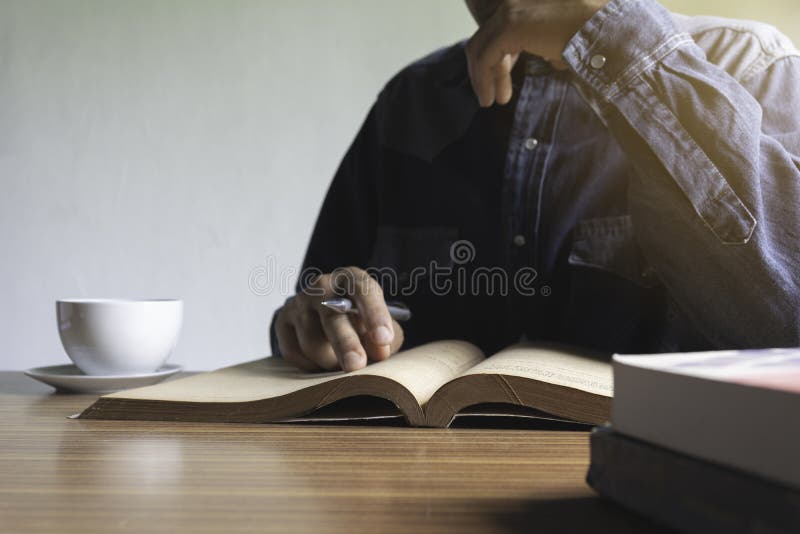 A Man Reading a Book Enjoys of Rest. Man Sitting and Reading a Book ...
