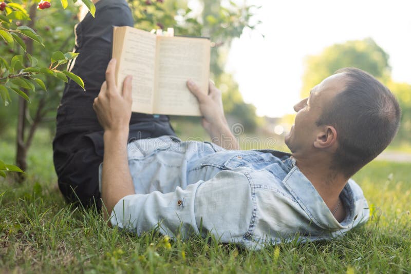Man Reading a Book on the Grass Stock Image - Image of green, happy ...