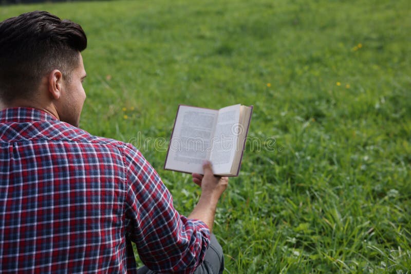 Man Reading Book on Green Grass, Back View Stock Photo - Image of grass ...