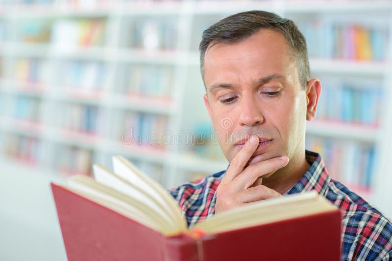 Man Reading Book in Library Stock Image - Image of paper, holding ...