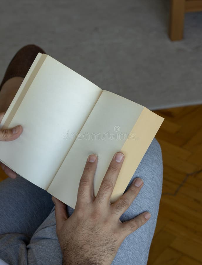 Man Reading a Book. he is Reading by Holding the Book Stock Image ...