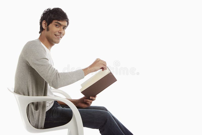 Man Reading a Book while Sitting Stock Image - Image of masculine ...