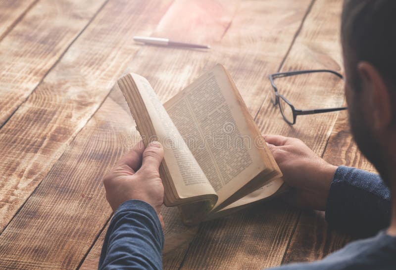 Man Reading Book Sitting at a Wooden Table Stock Photo - Image of cafe ...