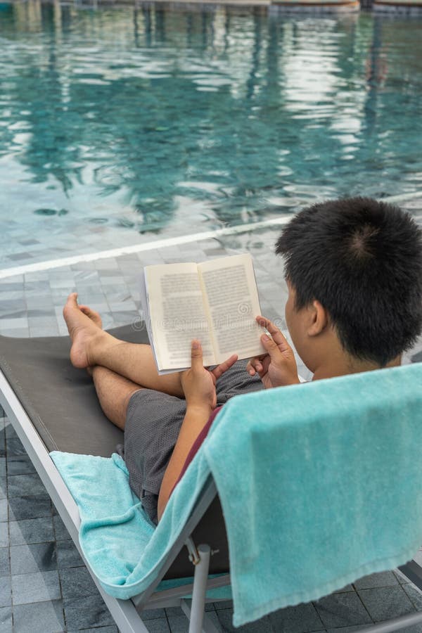 Man Reading Book at the Swimming Pool Stock Image - Image of freelance ...