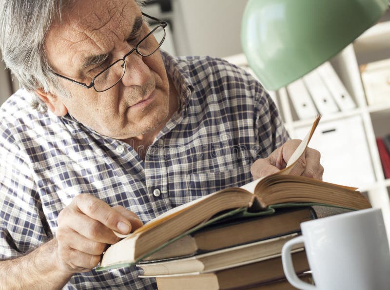 Man reading book on table stock image. Image of indoor - 79778061