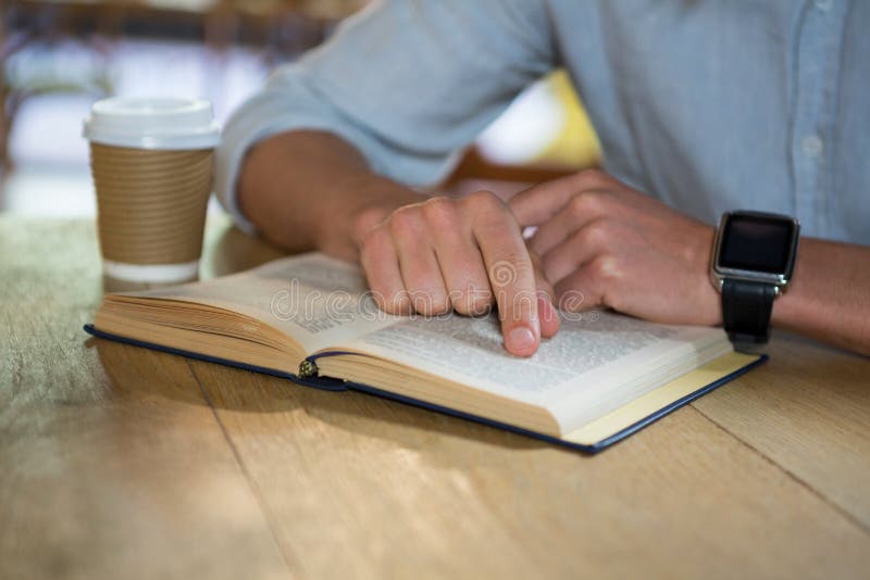 Man Reading Book at Table in Coffee Shop Stock Photo - Image of hobby ...