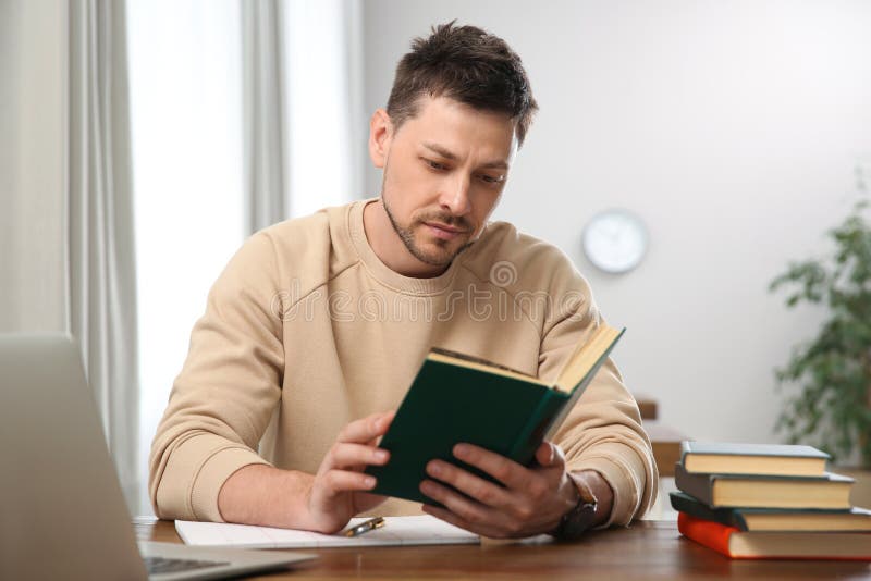 Man Reading Book at Table in Library Stock Photo - Image of public ...