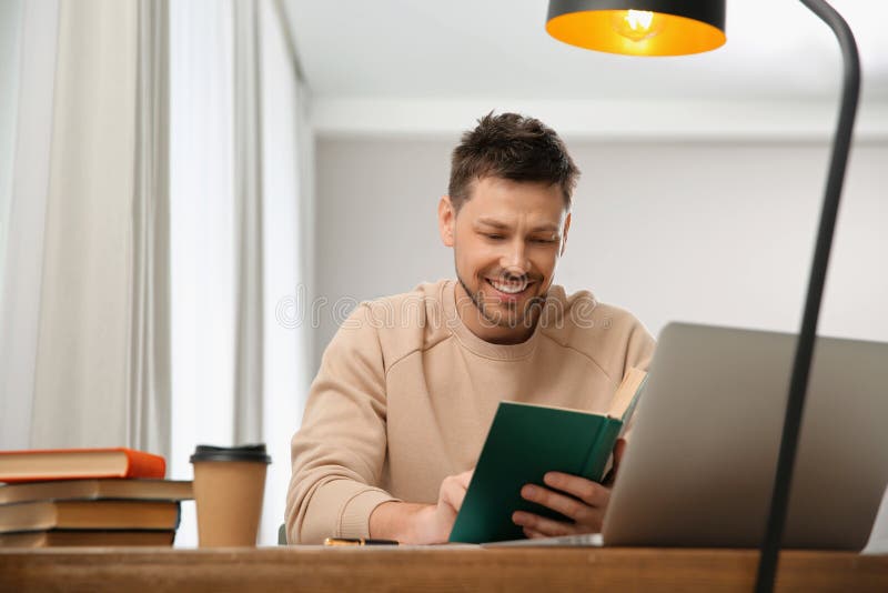 Man reading book at table stock photo. Image of exam - 225719718