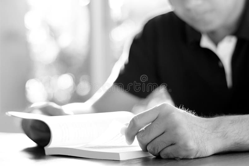 A Man Reading Book on the Table - Monochrome Effect Stock Photo - Image ...