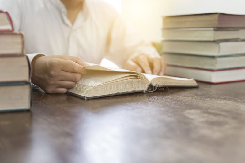 Man Reading Book with Textbook Stack on Wooden Desk Stock Image - Image ...