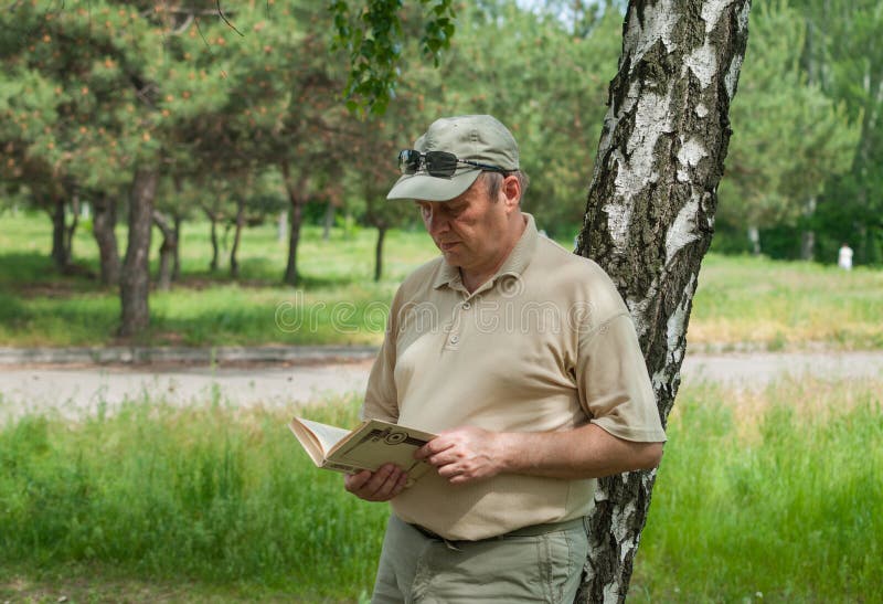 Man Reading Book Under Birch Tree Stock Image - Image of trunk, older ...