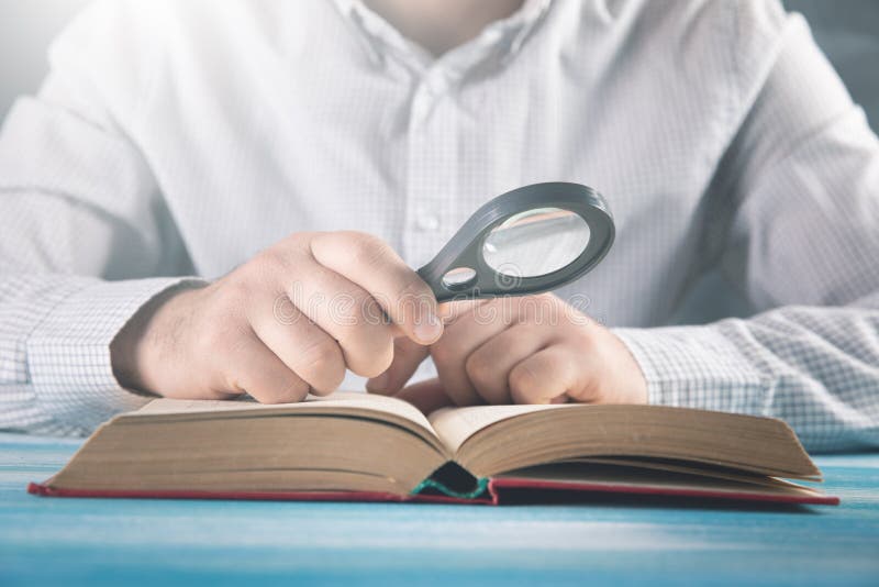 Man Reading a Book Using a Magnifying Glass Stock Image - Image of ...