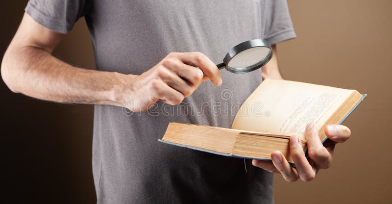 Man Reading a Book Using a Magnifying Glass Stock Photo - Image of ...