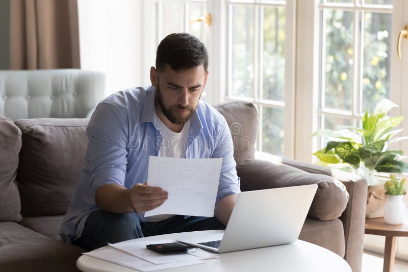 Man Reading Documents, Examining Bills Doing Paperwork at Home Stock ...