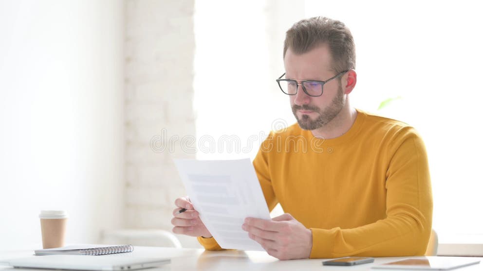 Man Reading Documents while Sitting in Office Stock Image - Image of ...