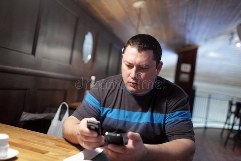 Man reading email in a pub stock image. Image of human - 30550405