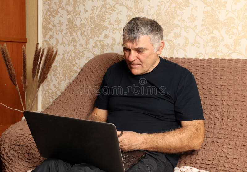 Man Reading Emails while Sitting on the Couch at Home Stock Image ...