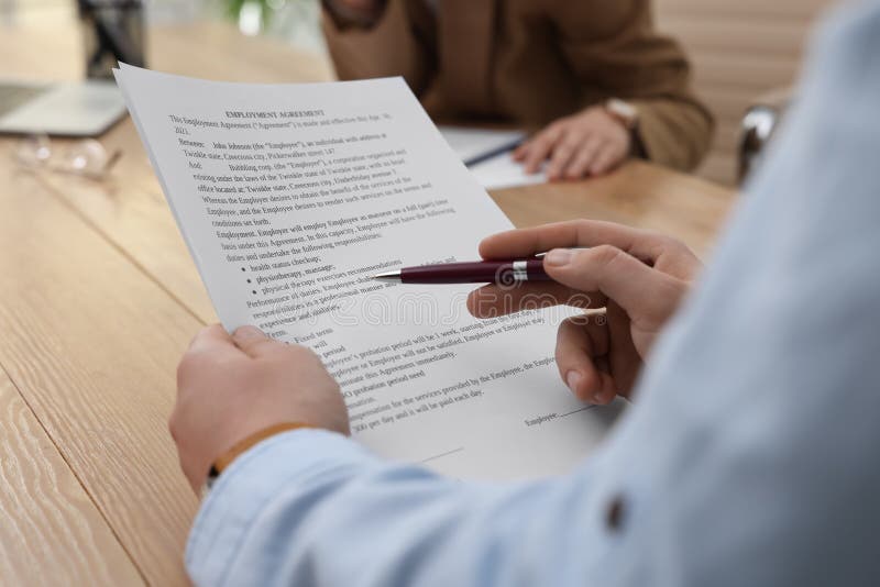 Man Reading Employment Agreement at Table in Office, Closeup. Signing ...