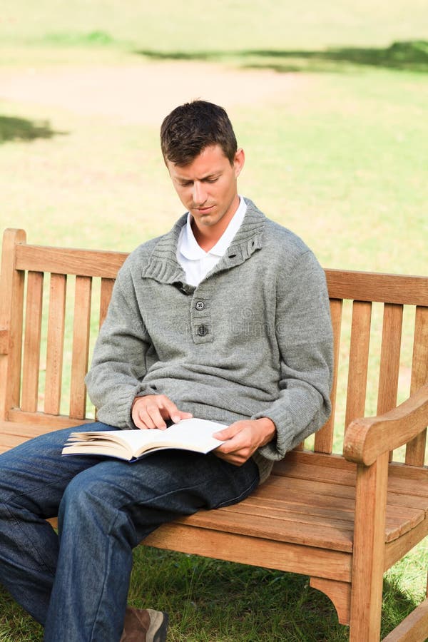 Man Reading His Book on the Bench Stock Image - Image of adult, outside ...