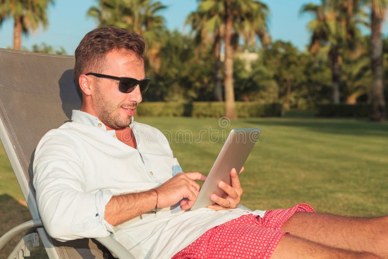 Man Reading on His Tablet and Touching Screen Stock Image - Image of ...