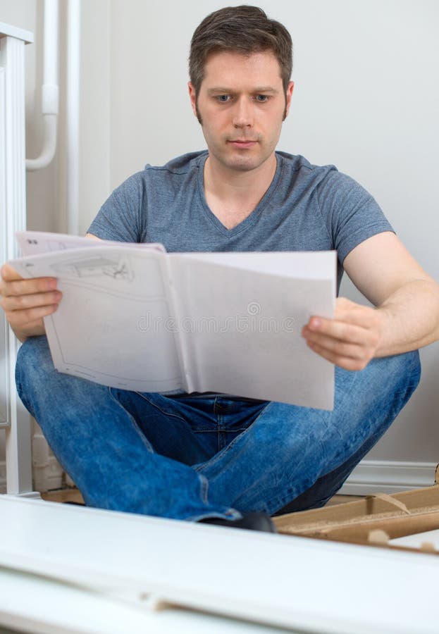 Man is Reading the Instructions. Stock Image - Image of handsome ...