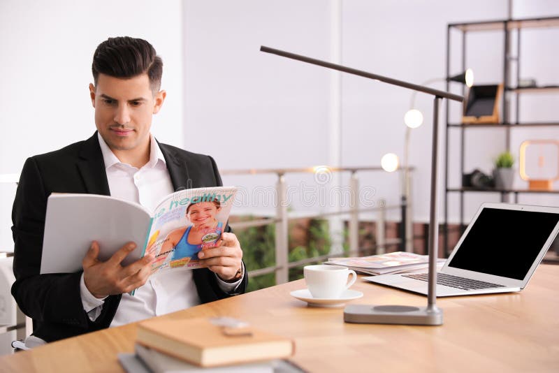 Man Reading Magazine at Table Stock Photo - Image of business, modern ...
