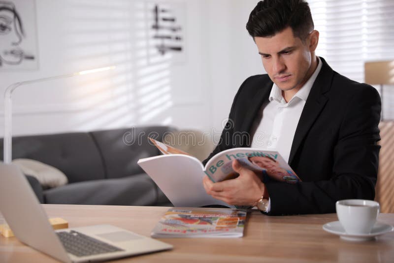 Man Reading Magazine at Table Stock Photo - Image of periodical, male ...