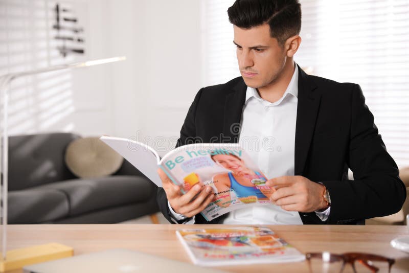 Man Reading Magazine at Table Stock Image - Image of business ...