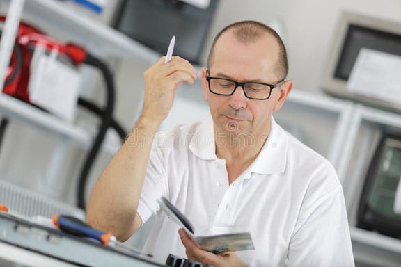 Man reading manual stock photo. Image of defective, service - 174010226